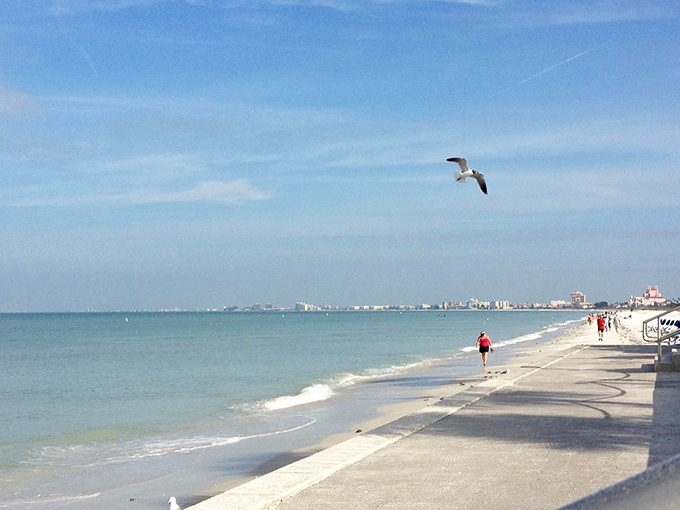 Postcard-perfect moments happen hourly here. A lone seagull surveys its domain while beachgoers stroll along the water's edge.