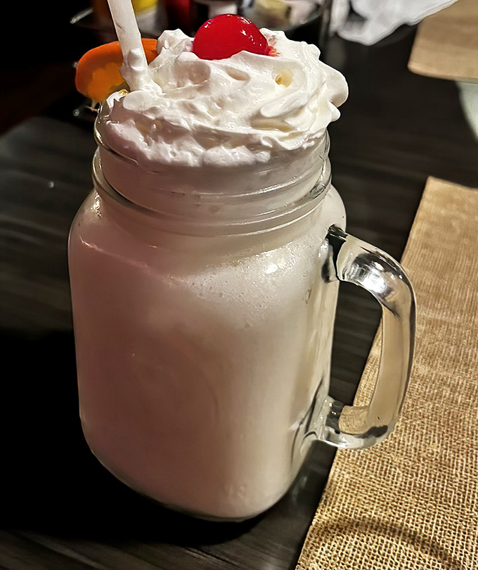 This creamy pi&ntilde;a colada topped with whipped cream and a cherry is vacation in a glass&mdash;the perfect sweet ending to your seafood feast.