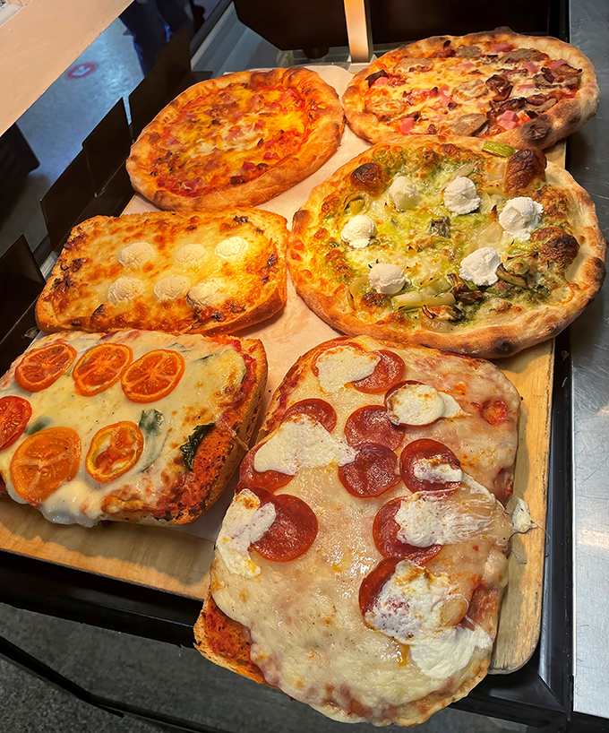 These aren't just pizzas—they're edible canvases where tomatoes and cheese have found their higher purpose in life.