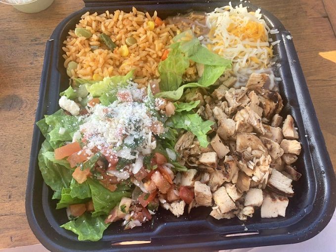 A plate divided into perfect quadrants of protein, rice, salad, and beans. This is what balance looks like in the Mexican food universe.