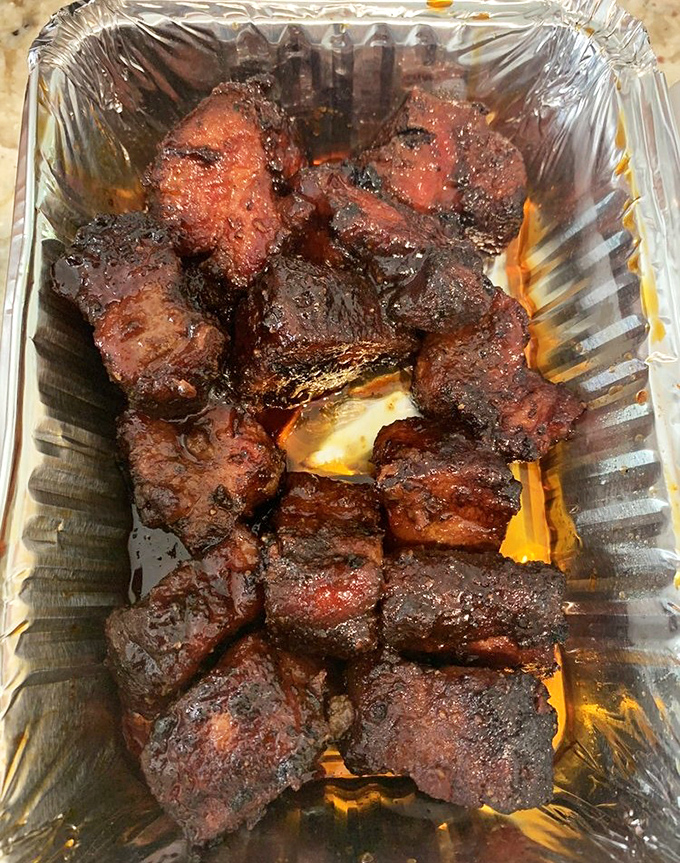 Pork belly burnt ends that look like little cubes of smoky heaven, each bite a masterclass in barbecue. 