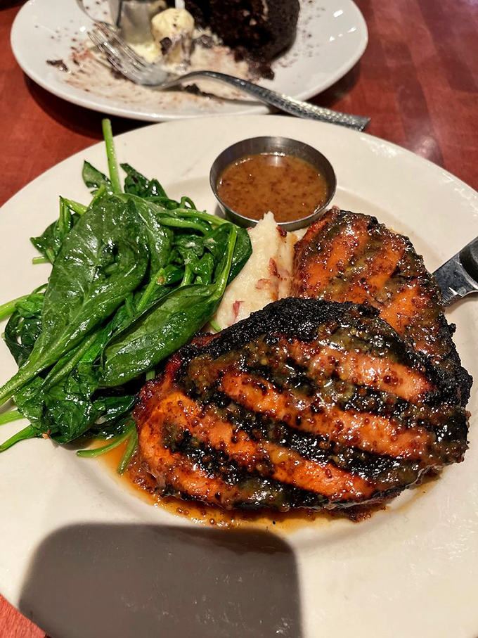 This pork chop has clearly been introduced to fire and spice in all the right ways, resulting in a caramelized exterior that protects juicy perfection within.
