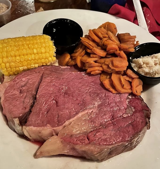 Prime rib so perfectly pink it belongs in a meat museum. The knife slides through it like it's cutting warm butter on a summer day.