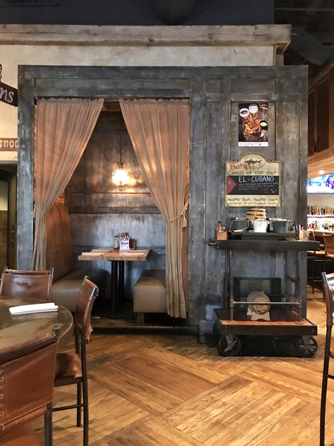 The private booth section: where intimate conversations happen over extraordinary food, curtained off from the world like a culinary confessional.