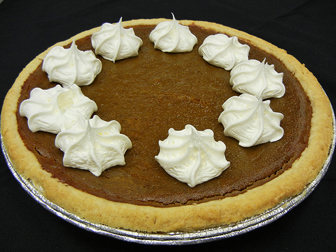Pumpkin pie with whipped cream dollops that look like little clouds of joy, proving that sometimes the classics become classics for a very good reason.