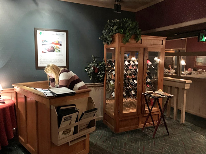 The host station and wine display&mdash;your first hint that this place takes both hospitality and proper wine storage seriously.