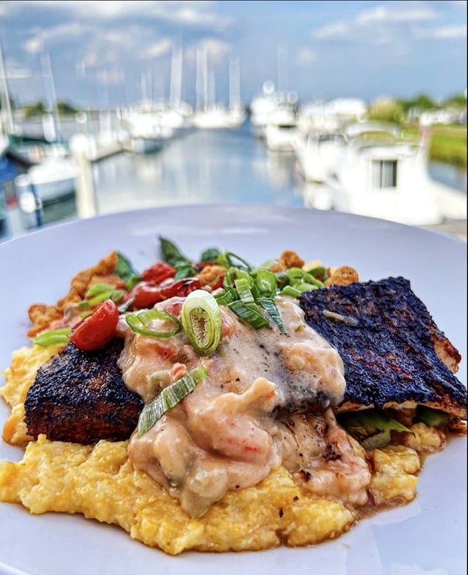 Blackened redfish atop golden grits with a marina view&mdash;because sometimes the perfect bite deserves the perfect backdrop to match its magnificence.
