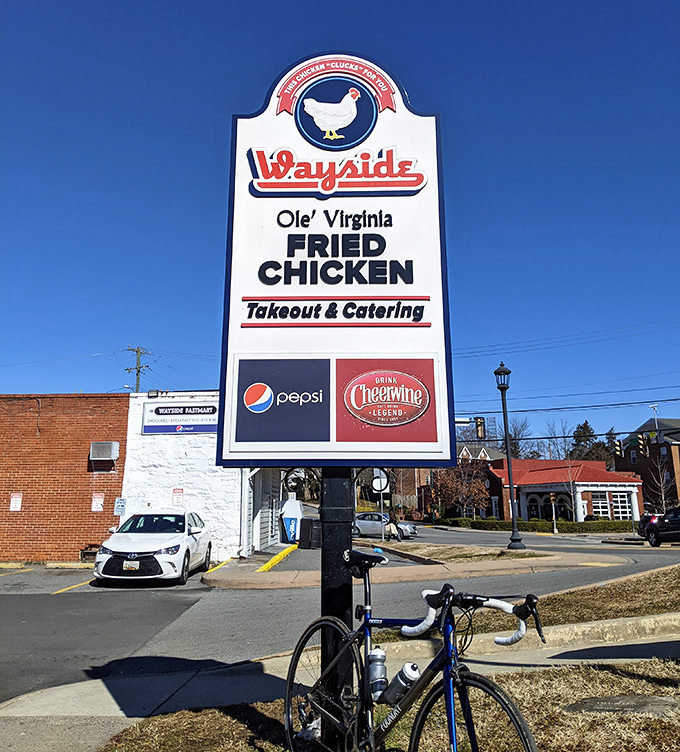 A roadside beacon guiding hungry travelers to fried chicken paradise. Like a lighthouse for your appetite, this sign has saved countless souls from mediocre meals.