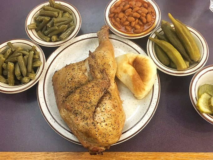 A perfectly roasted chicken quarter surrounded by a garden of sides. This isn't just dinner &ndash; it's edible Texas heritage on a plate.