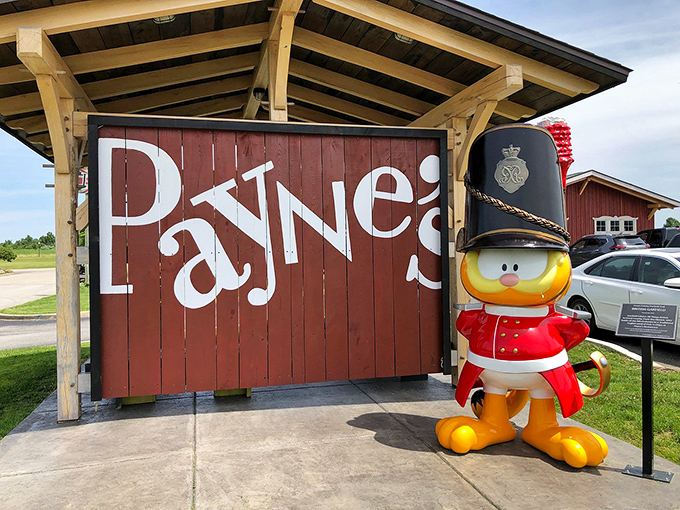 The playful duck mascot in royal guard attire stands sentinel beside the Payne's sign &ndash; a quirky British touch in the heart of Indiana.