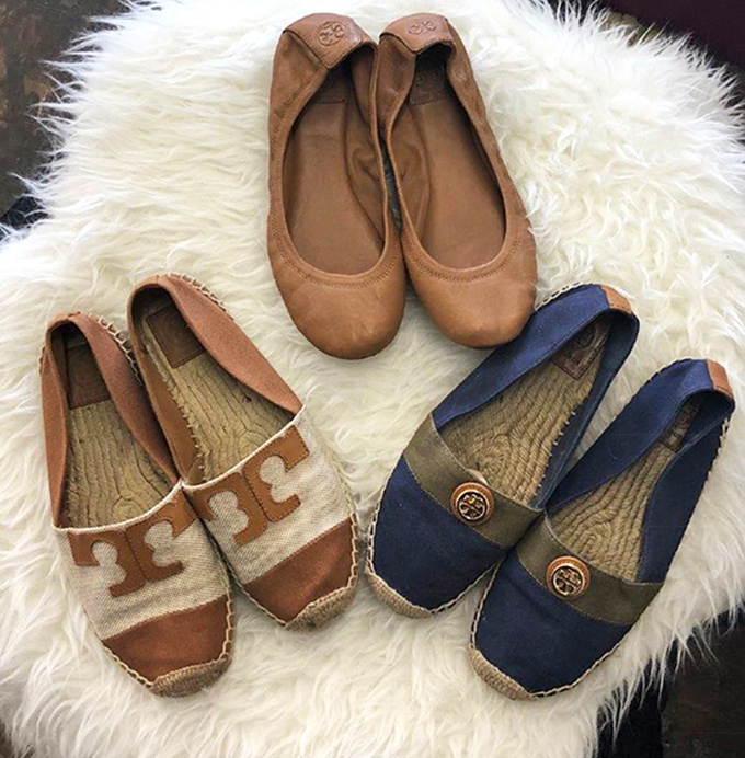 Designer espadrilles and ballet flats lounging on plush white fur. These gently loved Tory Burch beauties cost less than your morning latte habit for the week.