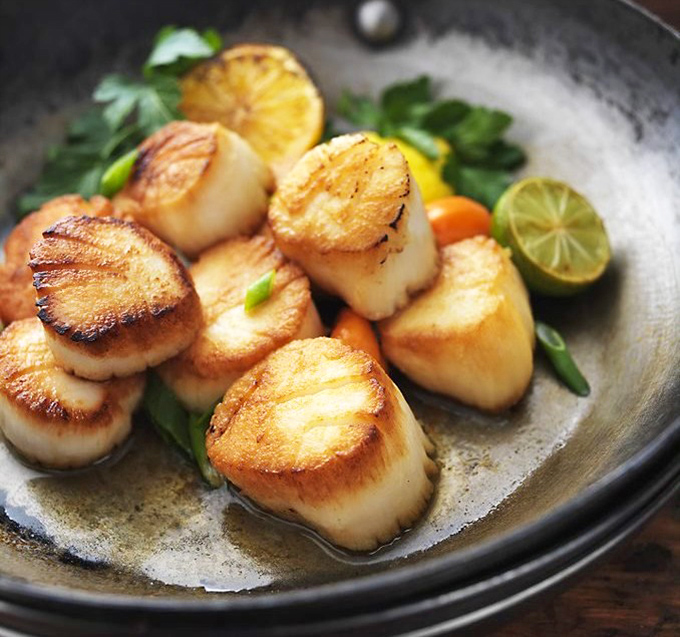 Perfectly seared scallops that look like they jumped from ocean to pan to plate in a single graceful movement. The caramelization is practically art.