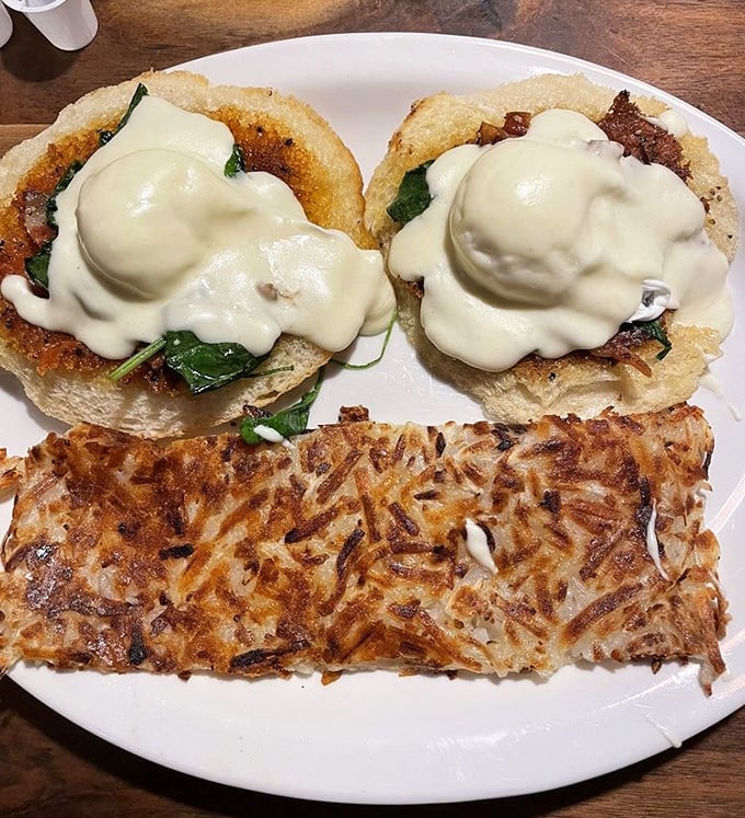 Breakfast reaches new heights with these Benedict-style creations, where hollandaise flows like a creamy yellow waterfall over perfectly toasted English muffins.