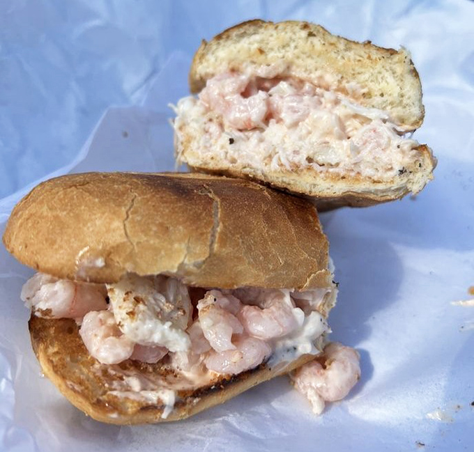 Plump bay shrimp spilling out of their bread containment unit. When your sandwich requires this much napkin commitment, you know it's worth it.