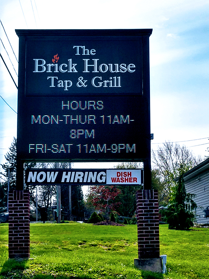 The sign that tells you everything you need to know: good hours, established presence, and they treat their staff well enough to need more.
