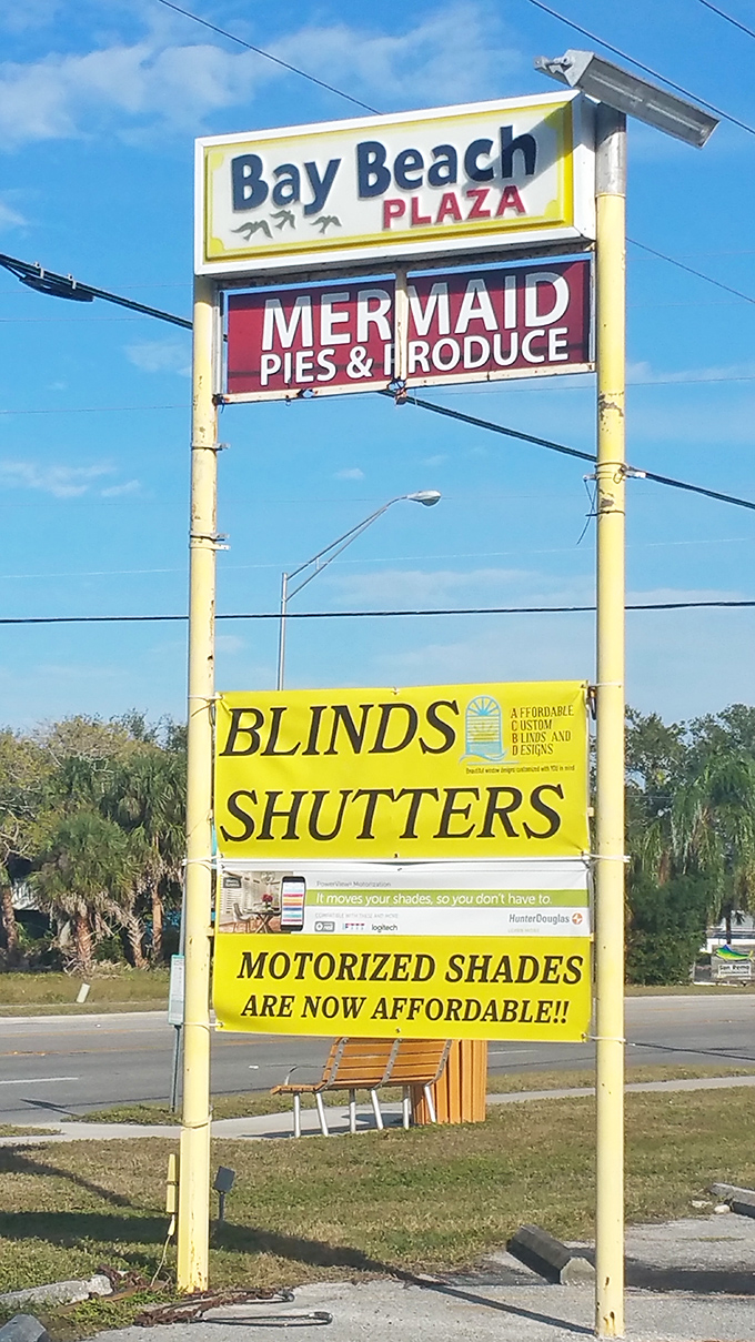 The Bay Beach Plaza sign stands tall against the Florida sky, a beacon guiding hungry travelers to pie paradise.