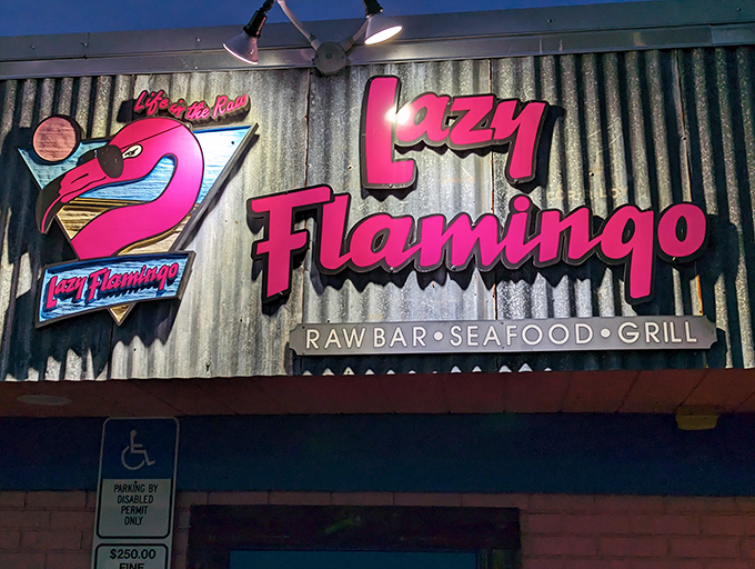 That neon pink sign isn't just a beacon for hungry travelers&mdash;it's a promise of the no-nonsense seafood paradise waiting inside.