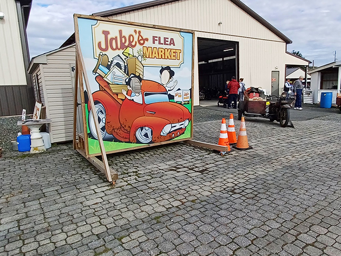 The iconic Jake's Flea Market sign welcomes bargain hunters with the promise of treasures waiting just beyond those orange traffic cones.