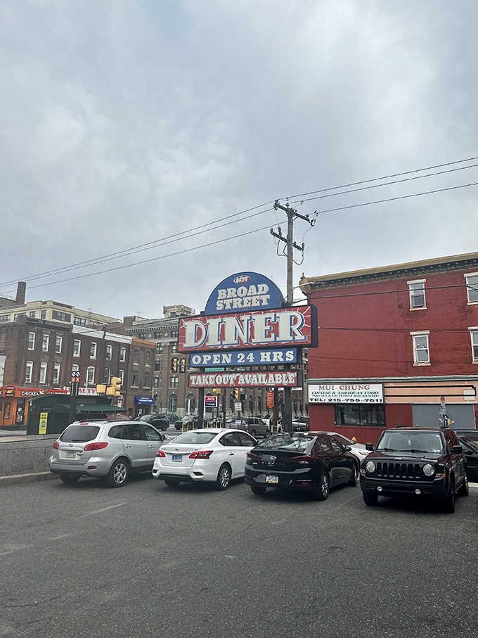 The neon sign glows like a lighthouse, guiding hungry travelers to safe harbor in a sea of culinary mediocrity.