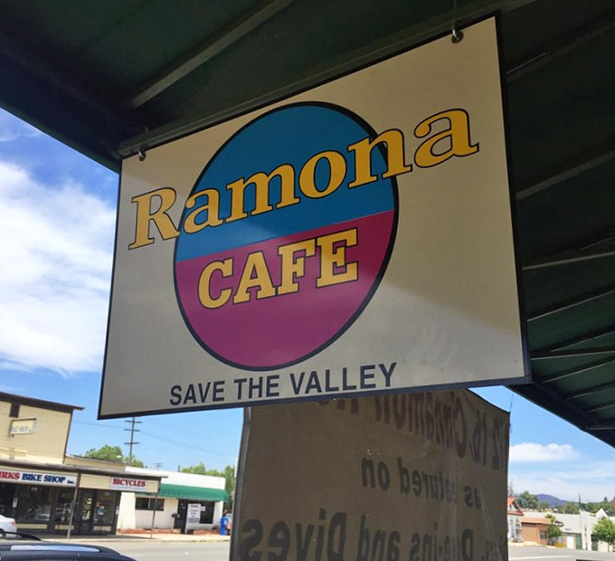 A sign that promises more than directions—it promises an experience. "Save the Valley" and satisfy your appetite in one strategic stop.