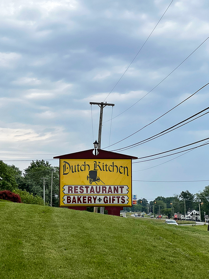 The roadside sign beckons like a yellow lighthouse for hungry travelers. Restaurant, bakery, AND gifts? It's the trifecta of roadtrip destinations.