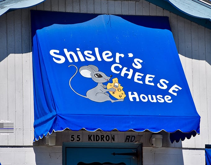 The cheese mouse mascot grins knowingly from the sign. He's aware you'll be leaving with more cheese than you planned.
