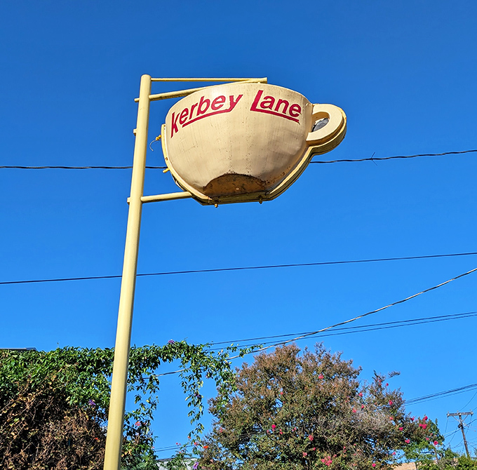 That coffee cup sign against the blue sky isn't just a logo – it's a beacon of hope for the hungry and caffeine-deprived across Austin.