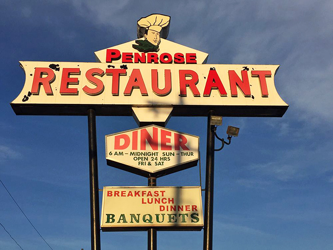 The vintage sign towers above Penrose Avenue, a neon beacon announcing to weary travelers that yes, breakfast is served all day, and yes, you've finally made it home.
