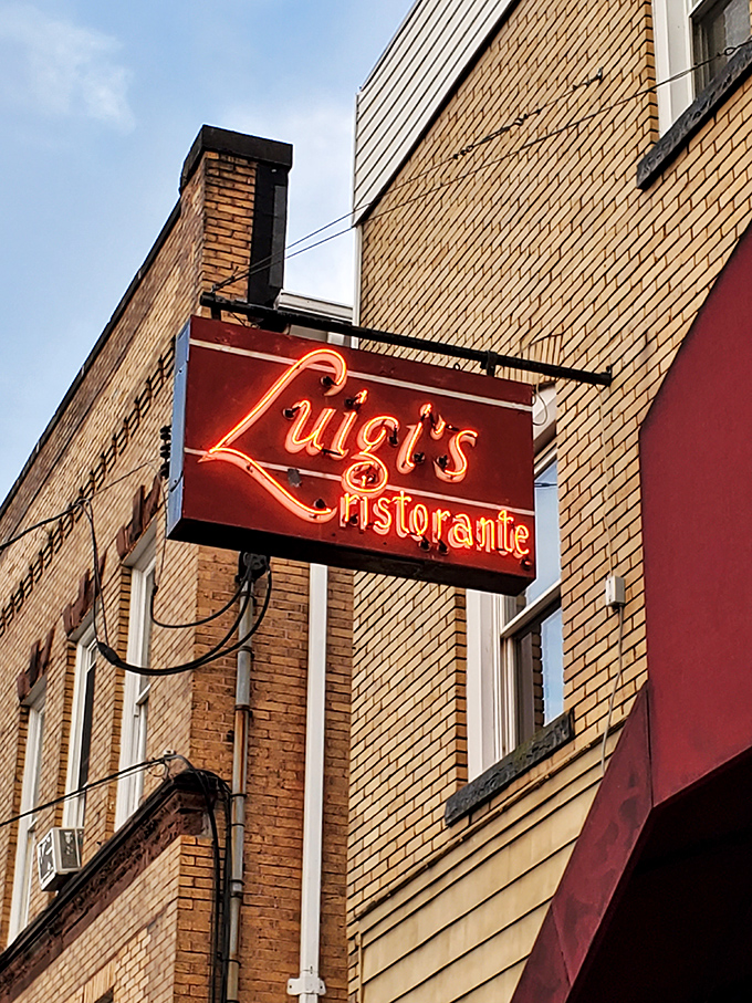 The neon sign glows like a lighthouse for hungry travelers, promising safe harbor from mediocre meals and culinary disappointments.