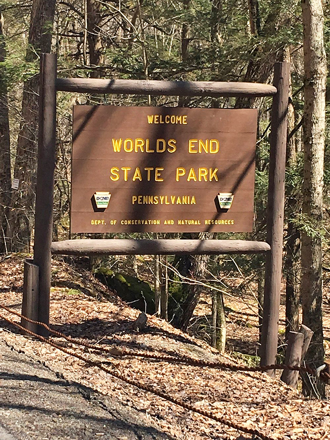 The park entrance sign: where your real vacation begins and your phone's signal bar count starts its rapid descent.