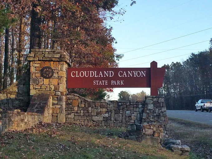 The entrance sign, framed by stone and autumn foliage, serves as Georgia's version of "You Are Now Entering Paradise"&mdash;no passport required.