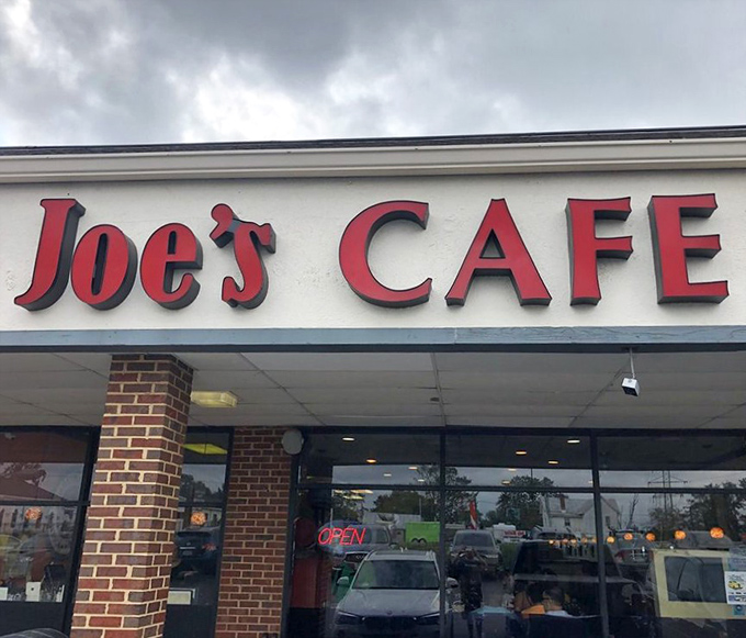 The red letters of Joe's Cafe stand bold against cloudy skies, a constant in an ever-changing world, promising the comfort of consistency to all who enter.