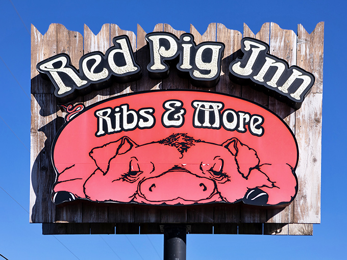 A sign that tells you exactly what you need to know: ribs, more, and a very happy pig who clearly knows something delicious.