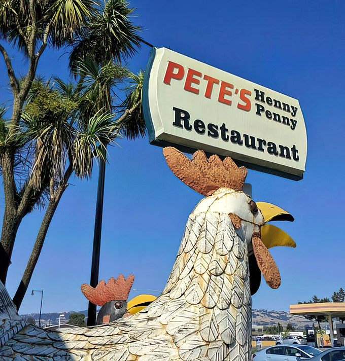 The iconic chicken sign stands tall against the California sky, a quirky landmark that's guided hungry travelers for generations.