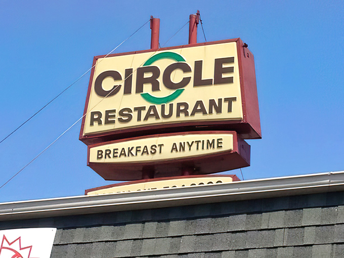 The sign proudly announces "BREAKFAST ANYTIME" against the blue sky&mdash;three syllables that sound remarkably like "I love you" to hungry travelers.