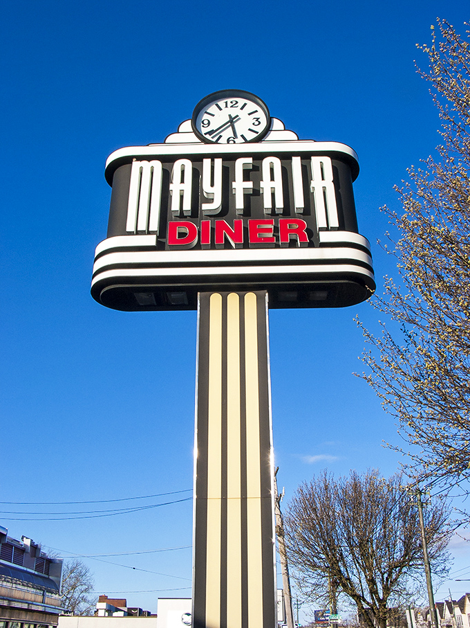 The iconic Mayfair sign stands tall against the blue Philadelphia sky, a mid-century masterpiece telling hungry travelers they've arrived.