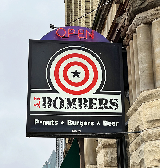 The iconic AJ Bombers sign promises the holy trinity of comfort food: peanuts, burgers, and beer. Has there ever been a more beautiful combination of words?