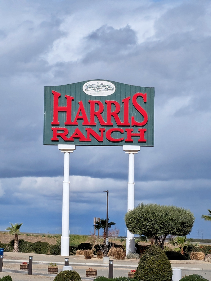 The iconic Harris Ranch sign stands tall against the Central Valley sky, a beacon of hope for hungry travelers seeking refuge from fast food mediocrity.
