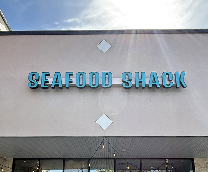 Sunlight kisses the Seafood Shack sign like it knows something you don't yet. This isn't just signage—it's your first clue that exceptional seafood awaits inside.