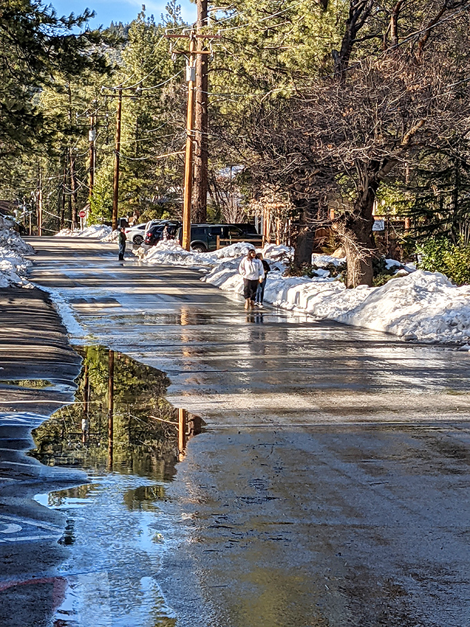 Winter's melting embrace creates impromptu reflections on Idyllwild's streets &ndash; nature's way of doubling the beauty for observant visitors.
