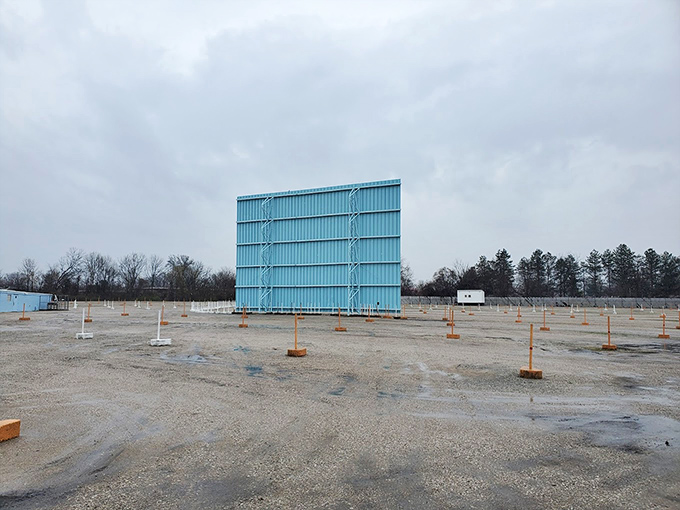 During daylight hours, the screen stands like a silent sentinel, patiently waiting for darkness to bring it roaring to life.