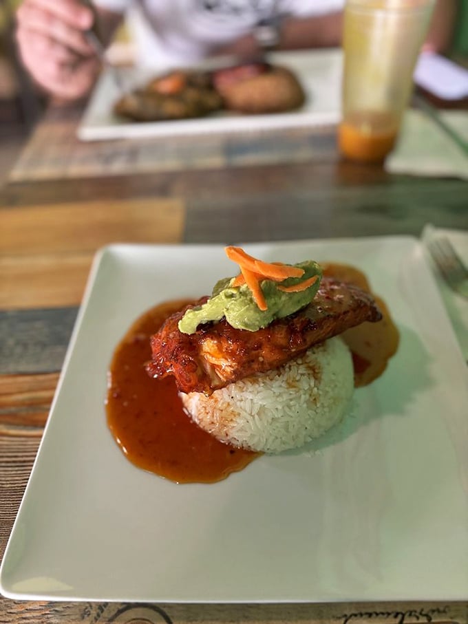 This isn't just salmon&mdash;it's a perfectly cooked fish throne atop a rice kingdom, crowned with avocado and surrounded by a moat of sauce worthy of royalty.