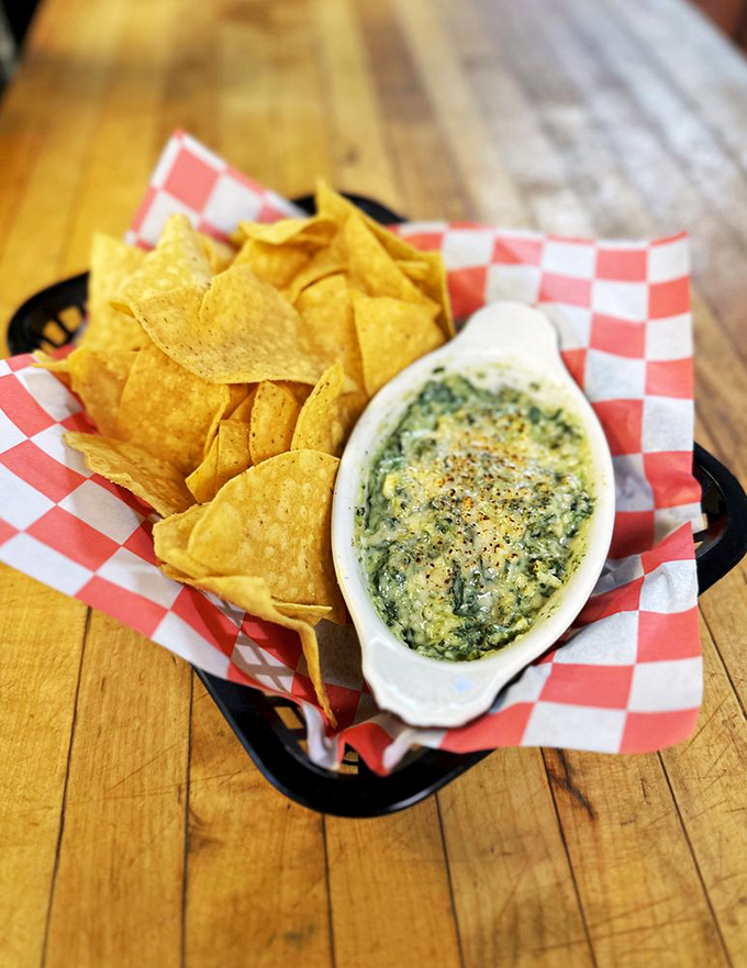 Spinach artichoke dip that achieves the perfect cheese pull with every chip. The kind of appetizer that makes you reconsider ordering a main course.