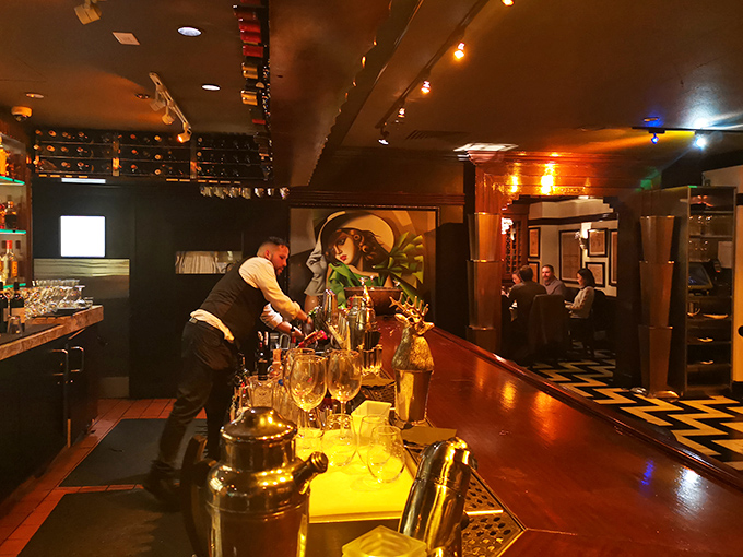Behind the scenes, Osso's bar staff crafts liquid magic in a warm, amber-lit space where bottles line up like soldiers ready for delicious duty.