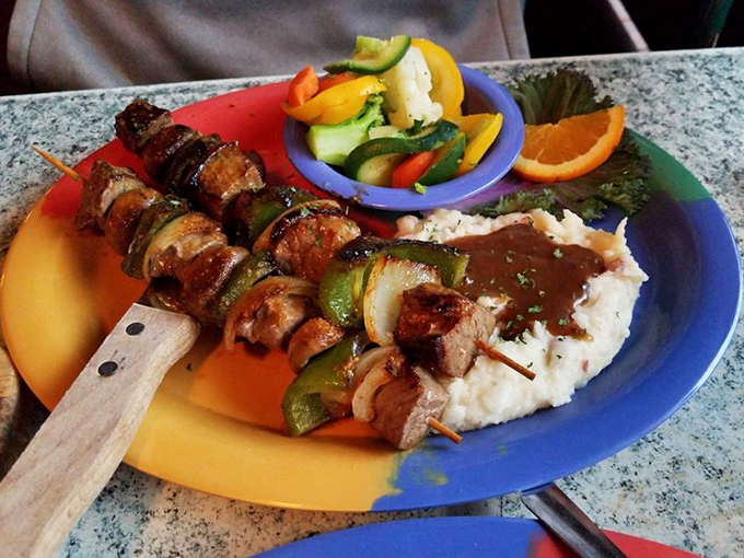 Kabobs: proof that food tastes better when impaled on a stick. These charred treasures rest on a cloud of mashed potatoes like savory lollipops for grown-ups.