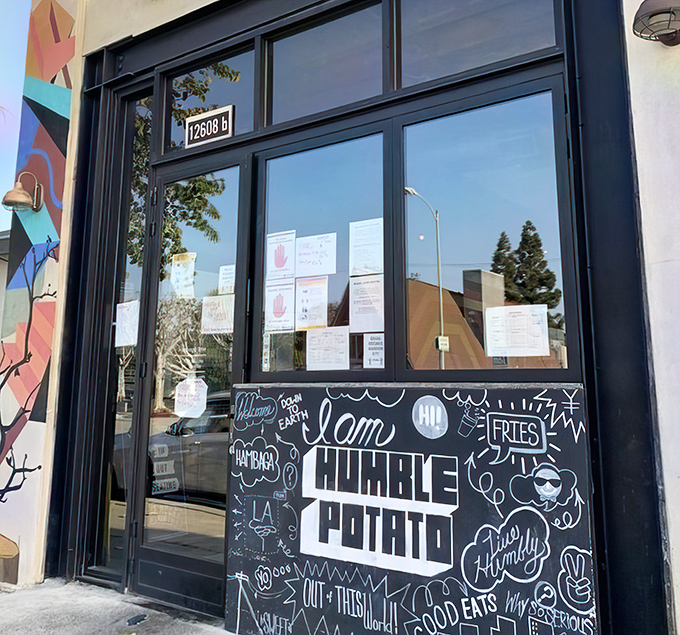 "I am Humble Potato" proclaims the chalkboard manifesto, surrounded by doodles that perfectly capture this restaurant's playful personality and serious food philosophy.