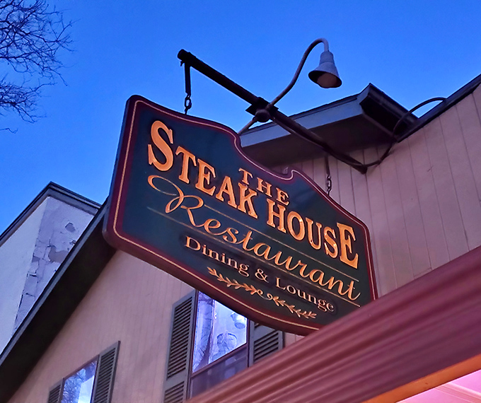 The illuminated sign glows against the twilight sky, a beacon of hope for the hungry and a promise of meaty delights within.