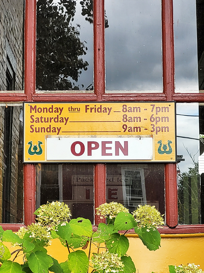These aren't just store hours&mdash;they're an invitation. A yellow sign promising that rural hospitality awaits, whether you arrive at 8am or just before closing.