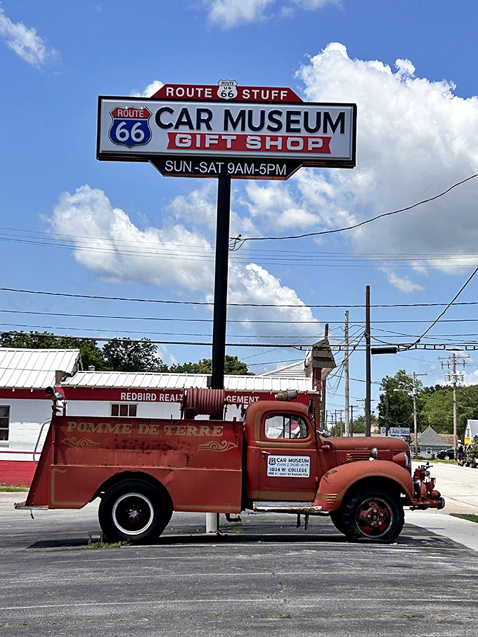 The museum's roadside sign beckons travelers like a beacon for automotive pilgrims seeking chrome-plated salvation.