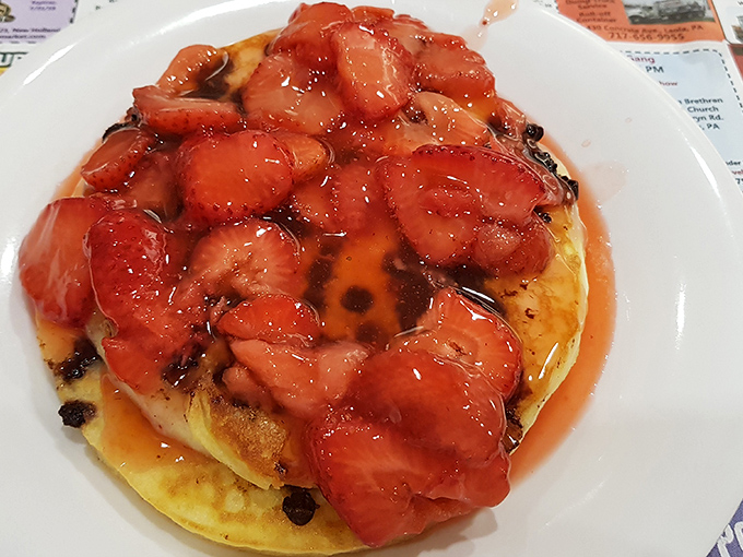 Pancakes crowned with fresh strawberries and syrup. Breakfast or dessert? In this judgment-free zone, it can gloriously be both.